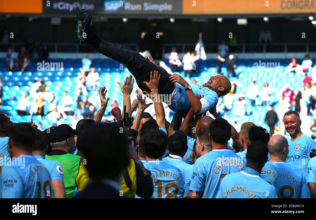 Manchester City players lifts manager Pep Guardiola in celebration ...