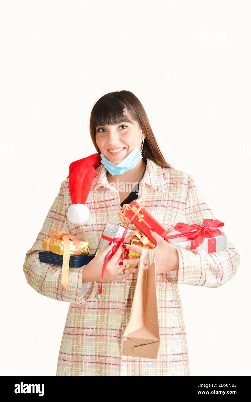 Smiling young woman with a Santa hat on her shoulder and a pulled down ...