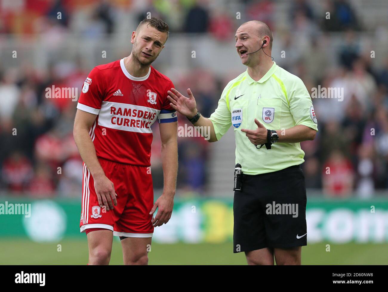 Middlesbrough's Ben Gibson (left) speaks with referee Bobby Madley ...