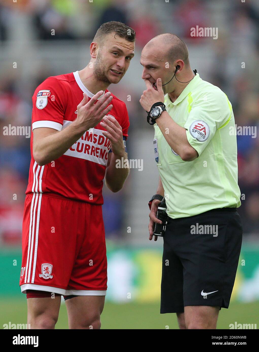 Middlesbrough's Ben Gibson (left) speaks with referee Bobby Madley ...