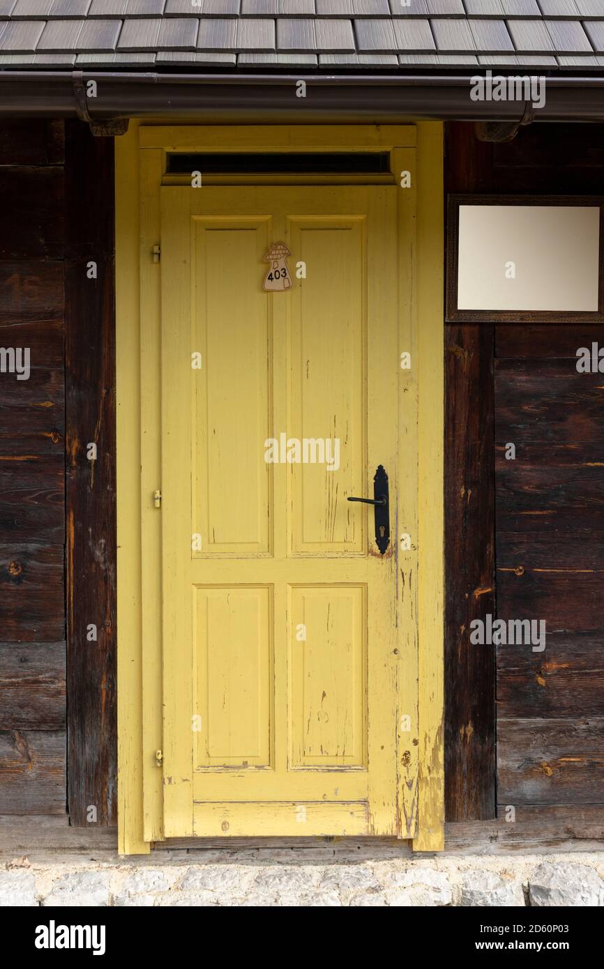 Vintage yellow cebine door at the wooden board wall Stock Photo - Alamy