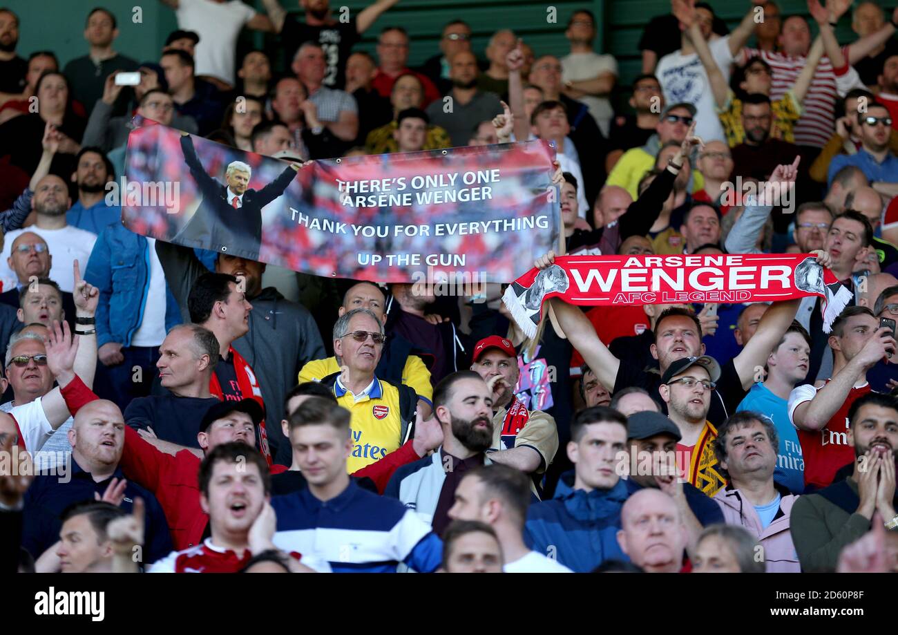 Arsenal fans in the stands hold up banners and scarves honouring ...