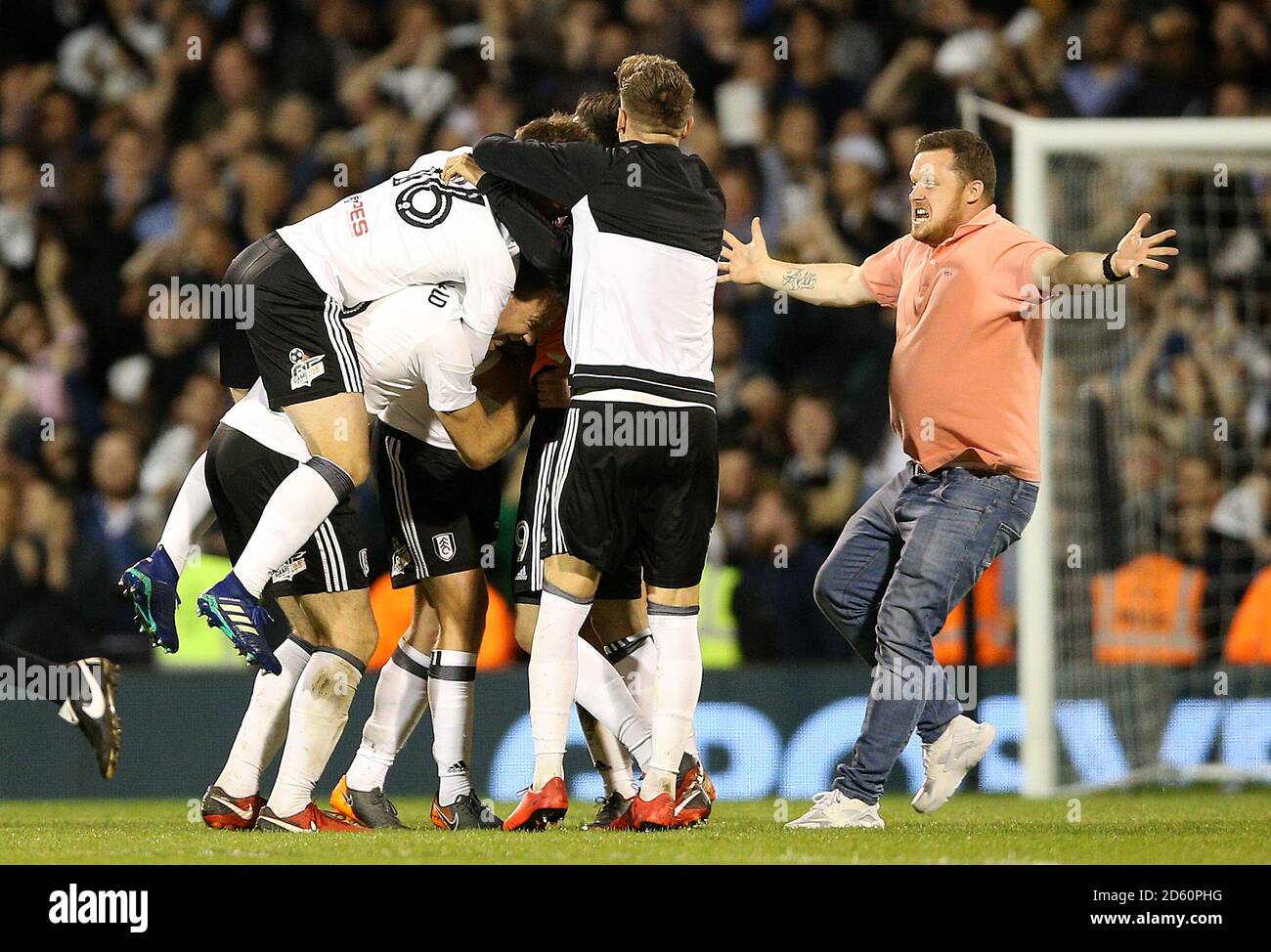 Pitch invaders celebrate with the players after the game Stock Photo ...