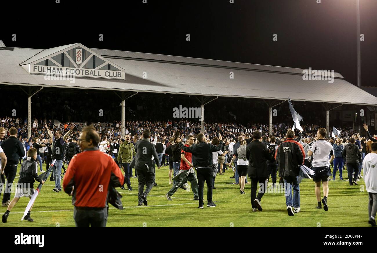 Fulham fans invade the Craven Cottage pitch after the final whistle ...