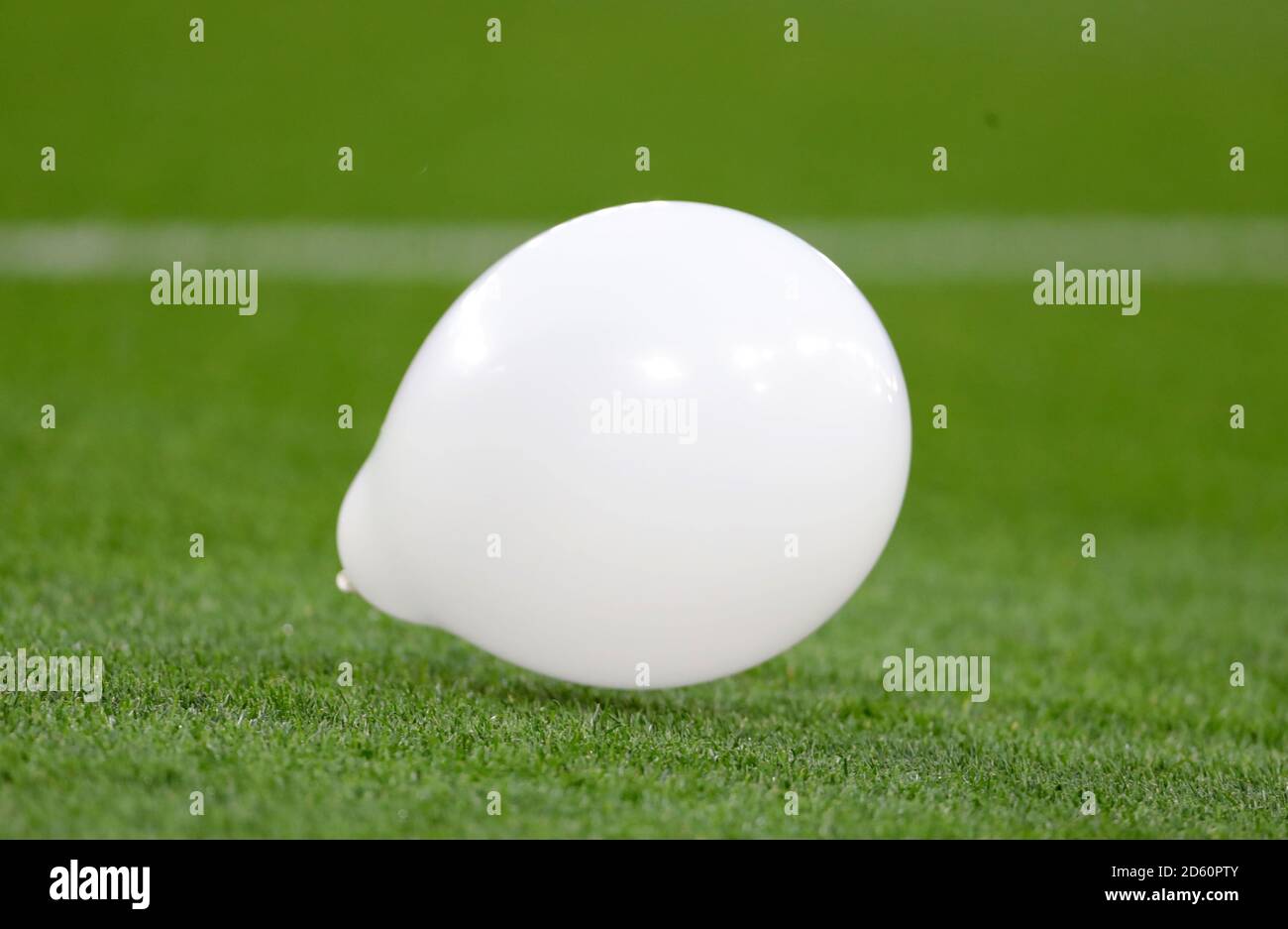 A white balloon on the pitch Stock Photo - Alamy
