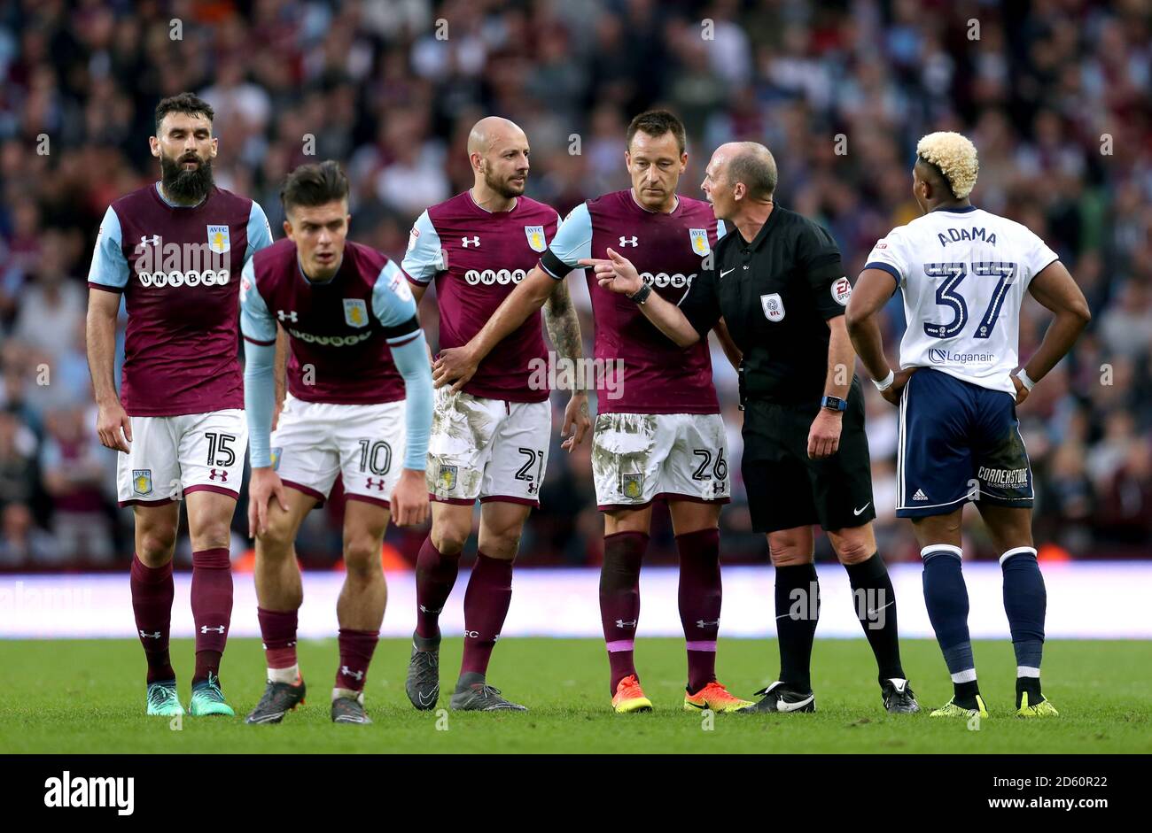 Aston Villa's Alan Hutton (centre) receives a yellow card for ...