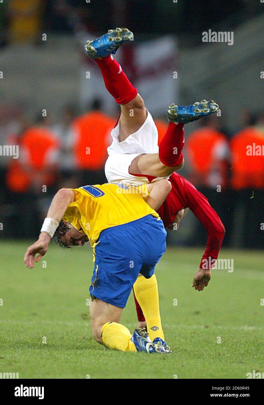 England's David Beckham is sent flying by Sweden's Johan Elmander Stock ...