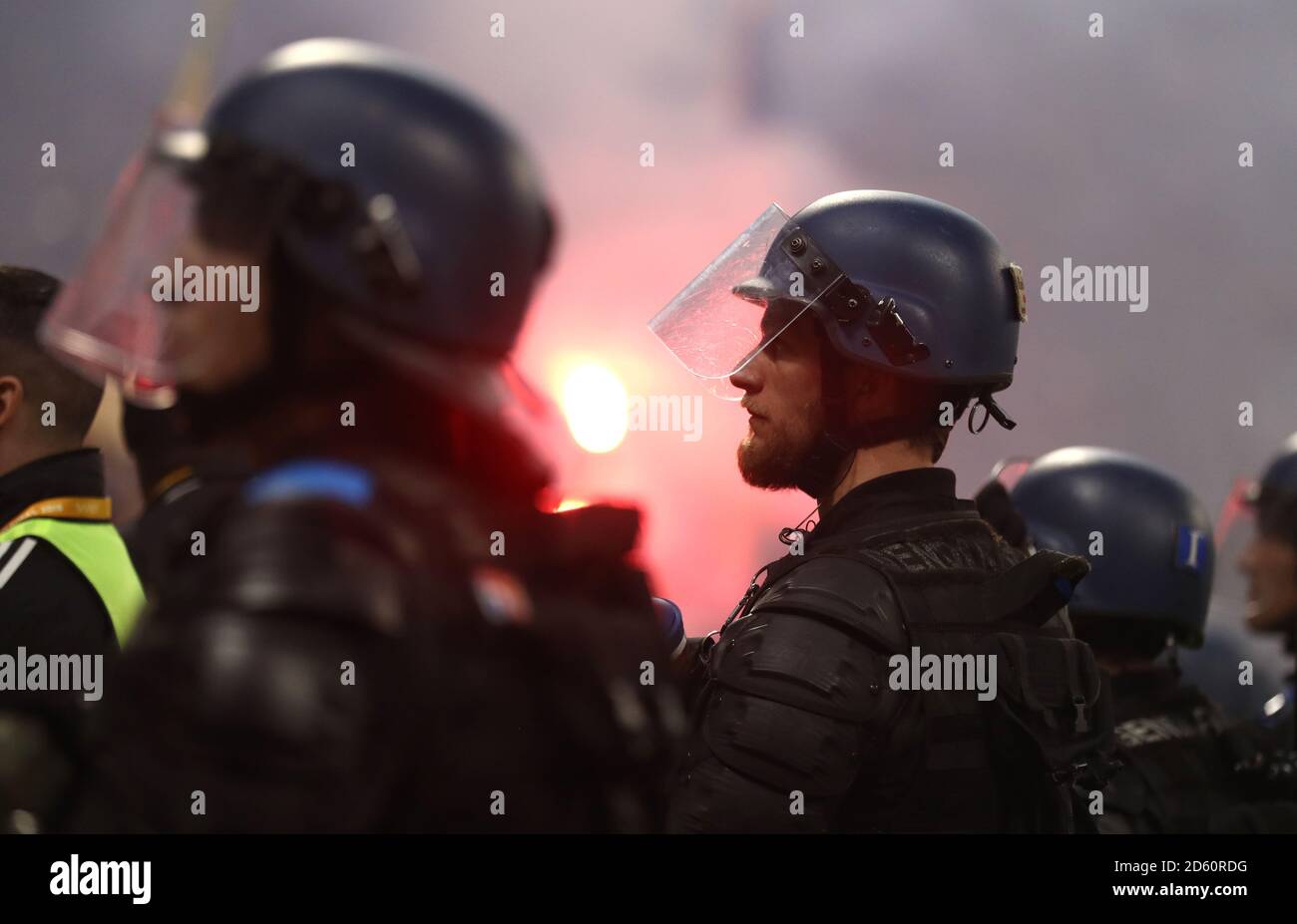 A Police officer wearing a riot mask looks on during the match Stock ...