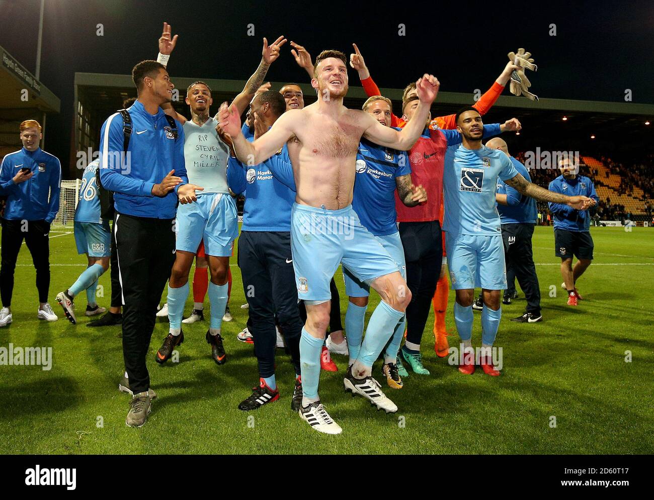 Coventry City's Chris Stokes (front) celebrates with players and staff ...