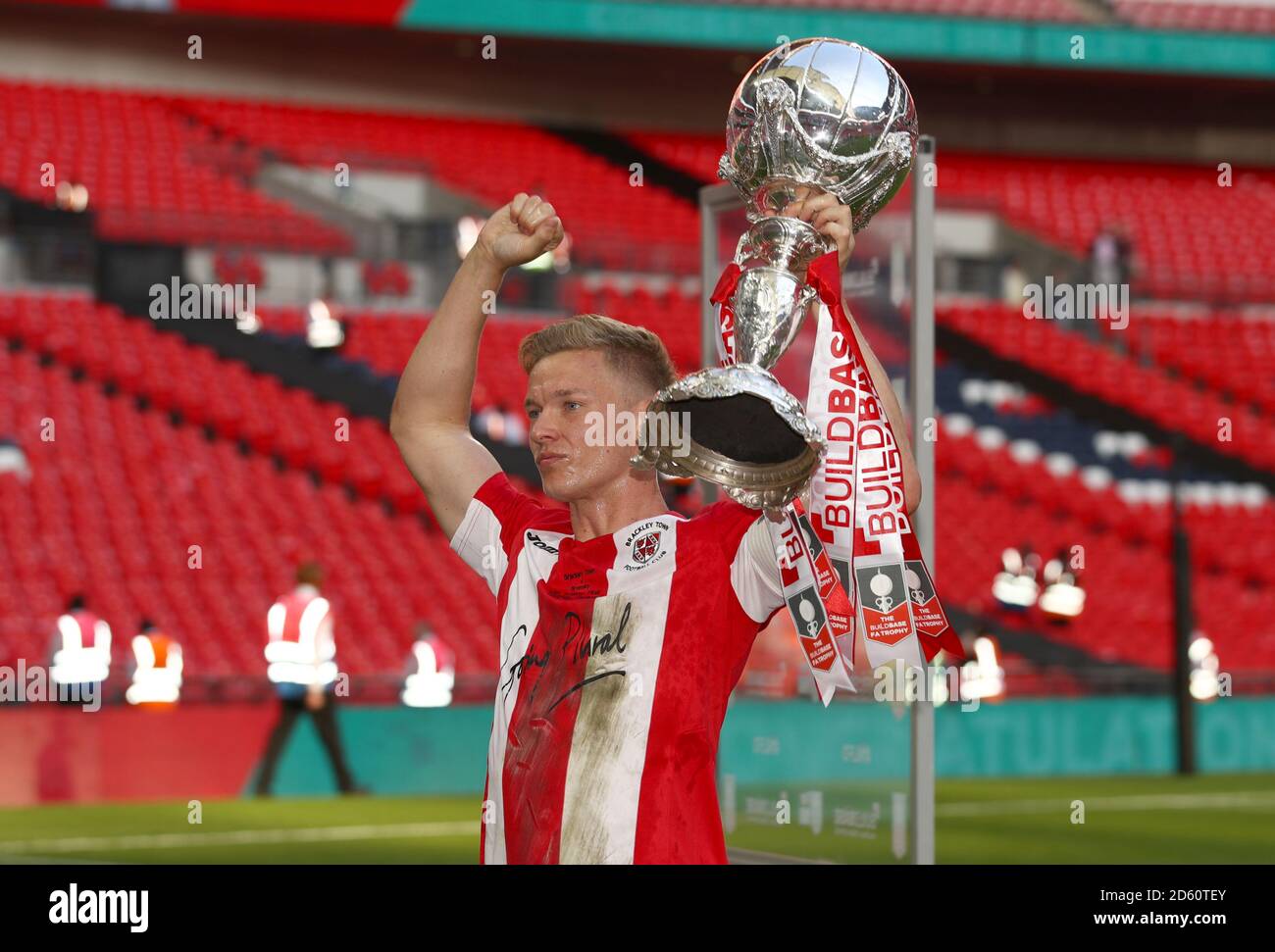 Brackley Town's Gareth Dean lifts the trophy after winning the ...