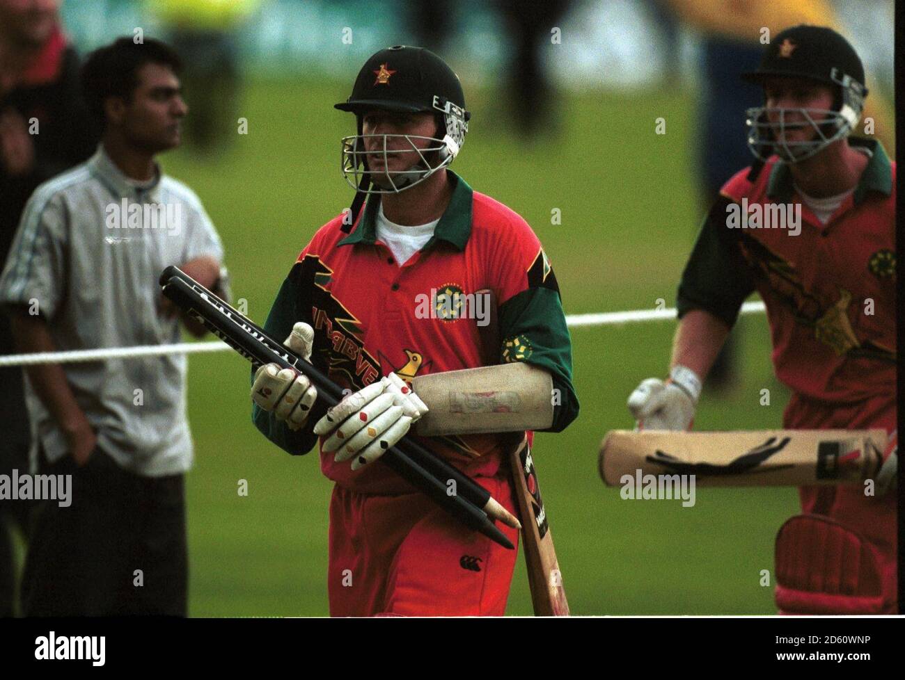 Zimbabwe's Guy Whittall walks off the pitch carrying two souvenir ...