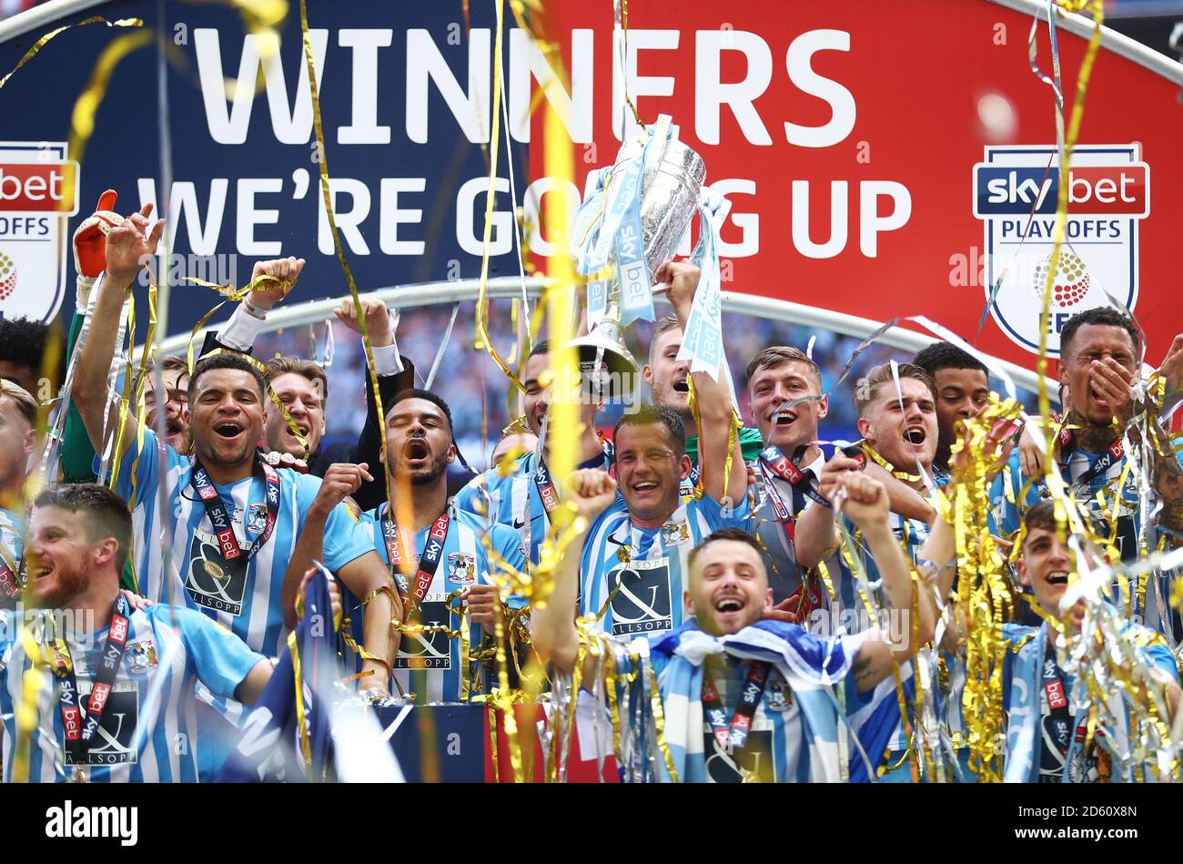 Coventry City's Michael Doyle (centre) lifts the trophy with his team ...