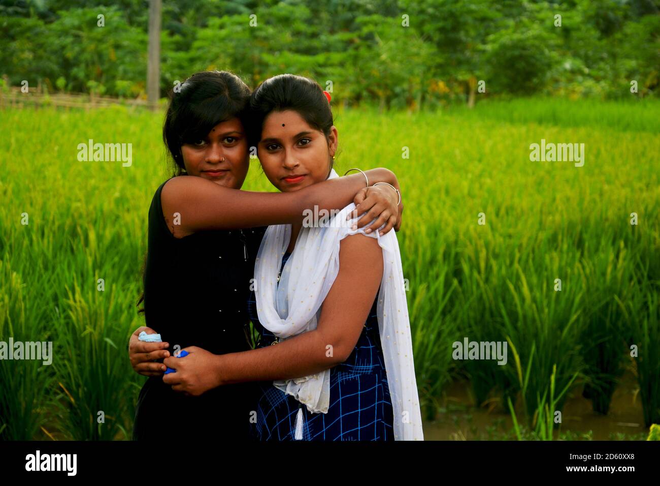 Close of two teenage girls wearing colorful Indian dresses of salwar ...
