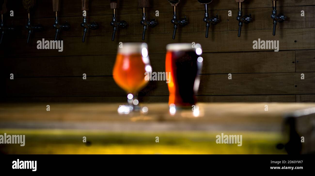 Fresh draft beer dispensers behind Stock Photo - Alamy