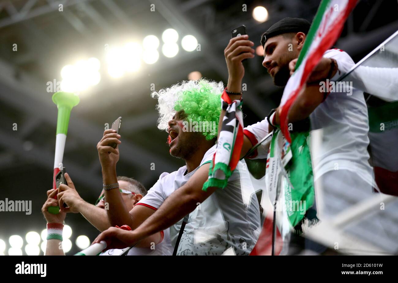Iran fans in the stands show their support with banners, wigs and face ...