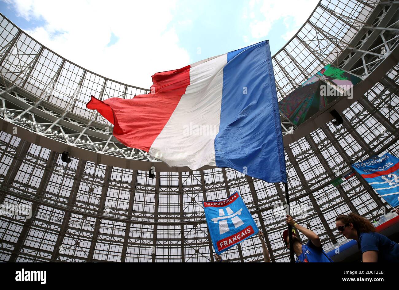 France fans wave flags in the build-up to the game Stock Photo - Alamy