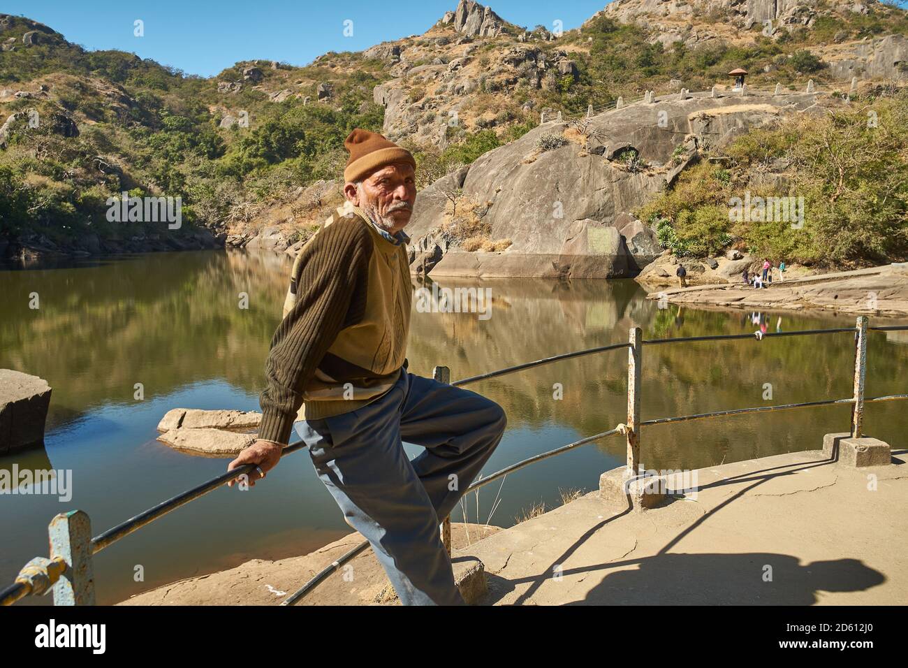 A forest guard keeps watch over tourists at the Trevors Tank in Mount ...