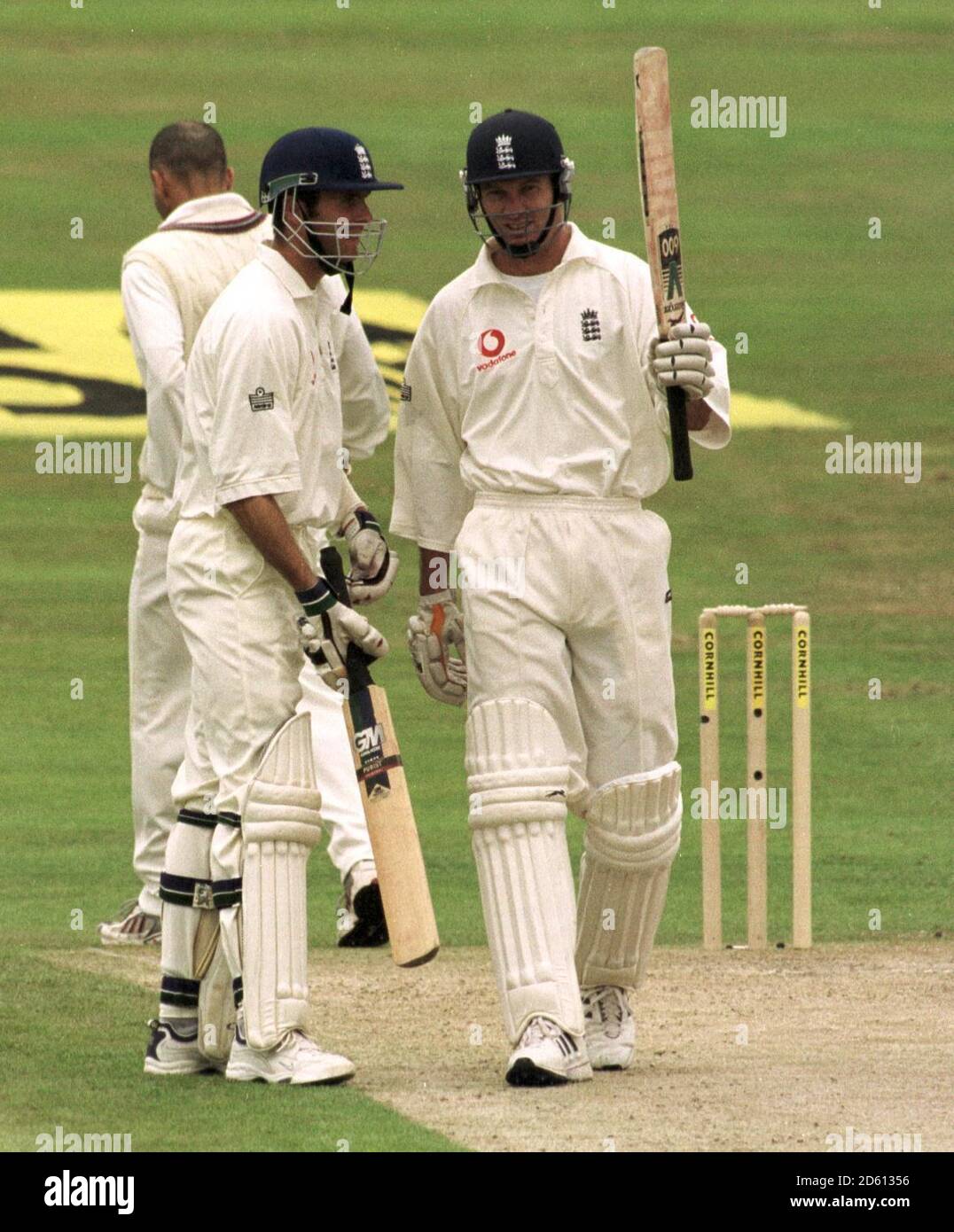 England's Graeme Hick (r) celebrates his 50 with Michael Vaughan (l ...