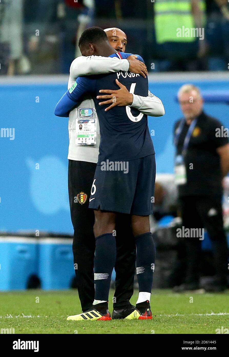 Belgium assistant coach Thierry Henry (left) with France's Paul Pogba ...