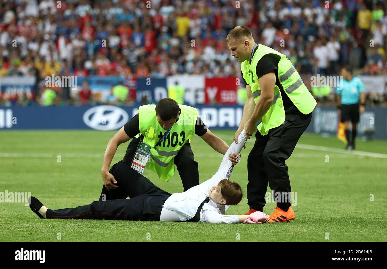 Pitch invaders are tackled by secuirty staff during the FIFA World Cup ...