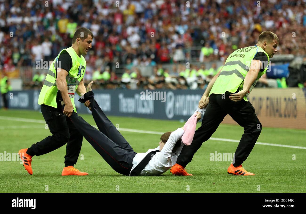 Pitch invaders are tackled by secuirty staff during the FIFA World Cup ...