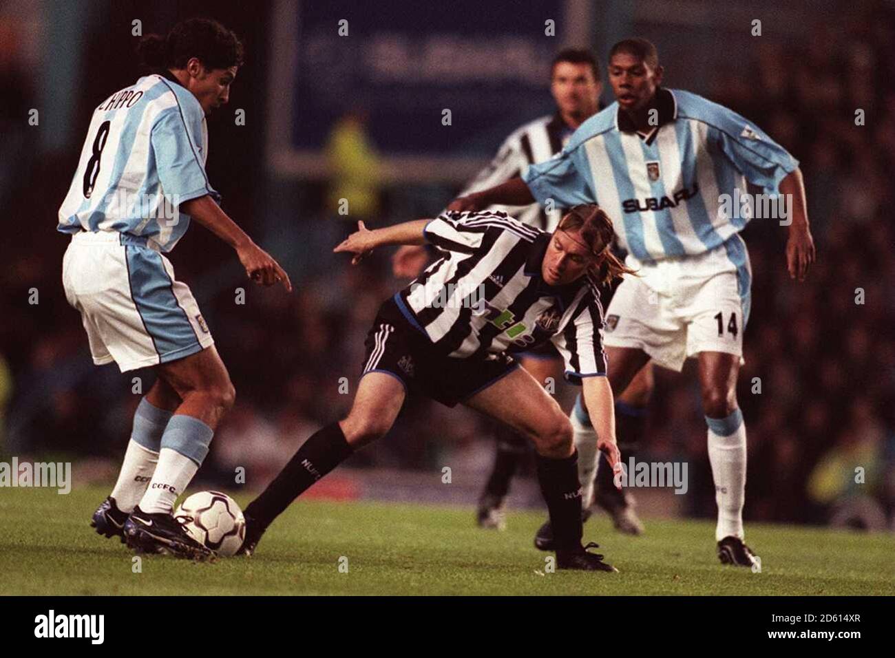 Coventry City's Youssef Chippo (l) and Carlton Palmer (r) tackle ...