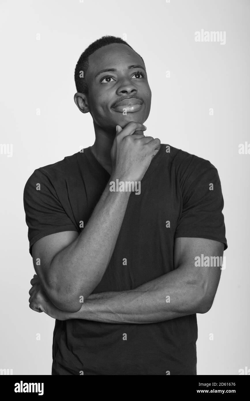 Portrait of young handsome African man thinking Stock Photo - Alamy