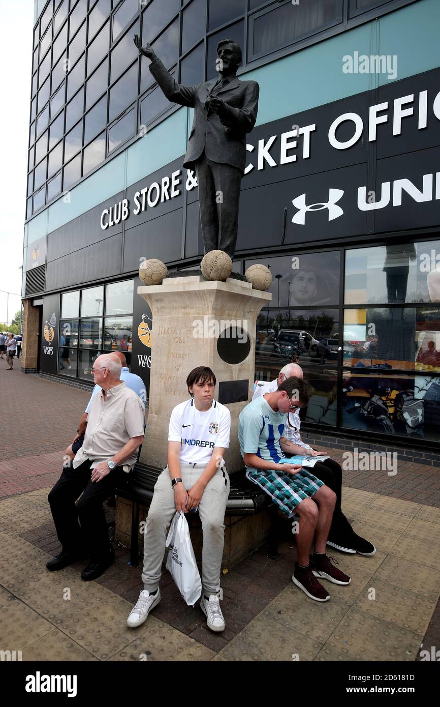 Coventry City fans sit around the Jimmy Hill statue at the Ricoh Arena ...