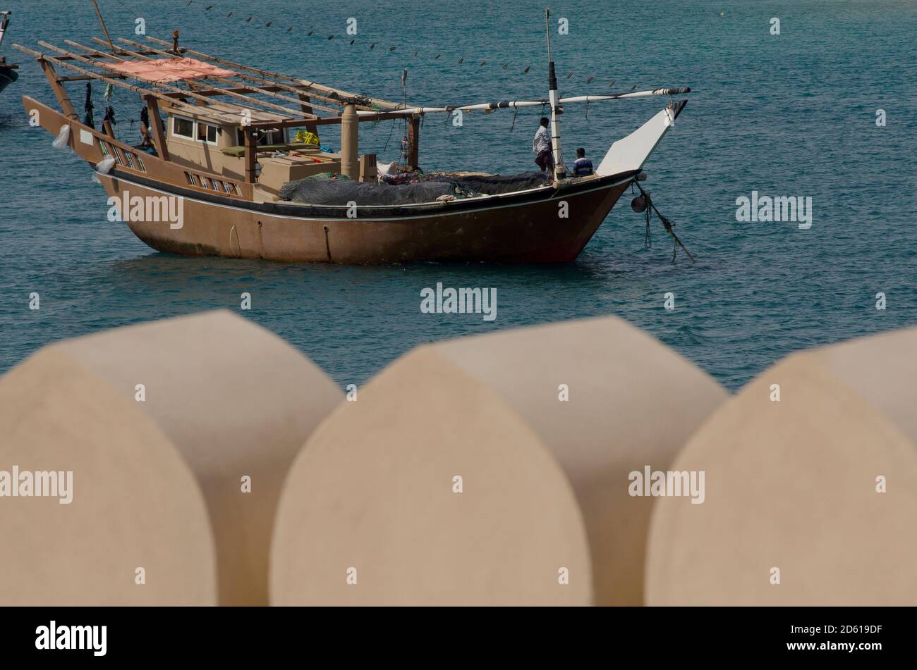 Traditional wooden Dhows moored at the harbour in Sur on the coast of ...