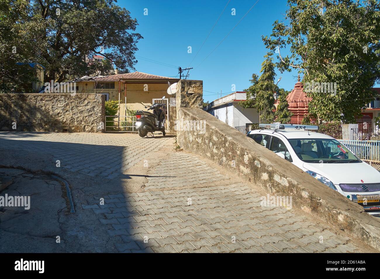 A typical driveway on sloping road between the streets and houses of ...