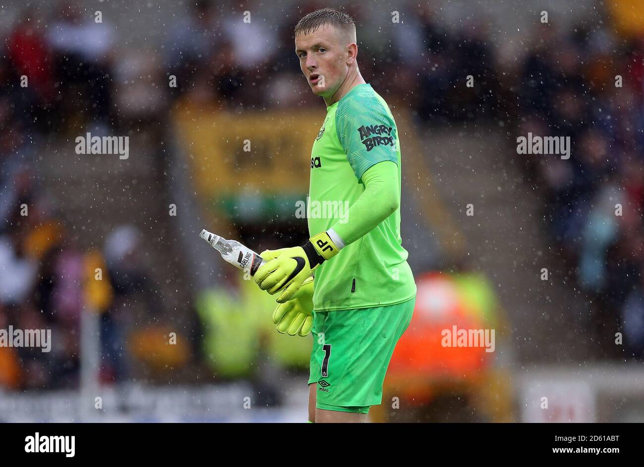 Everton's keeper Jordan Pickford removes a bottle thrown on the pitch ...