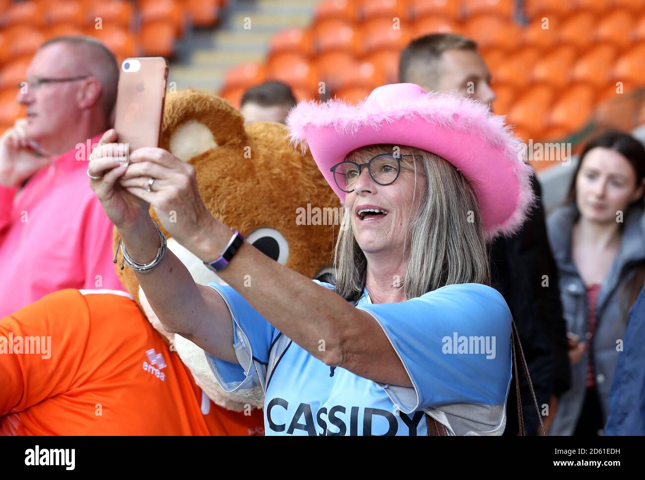Coventry City fan takes a photo with the Blackpool mascot Bloomfield ...