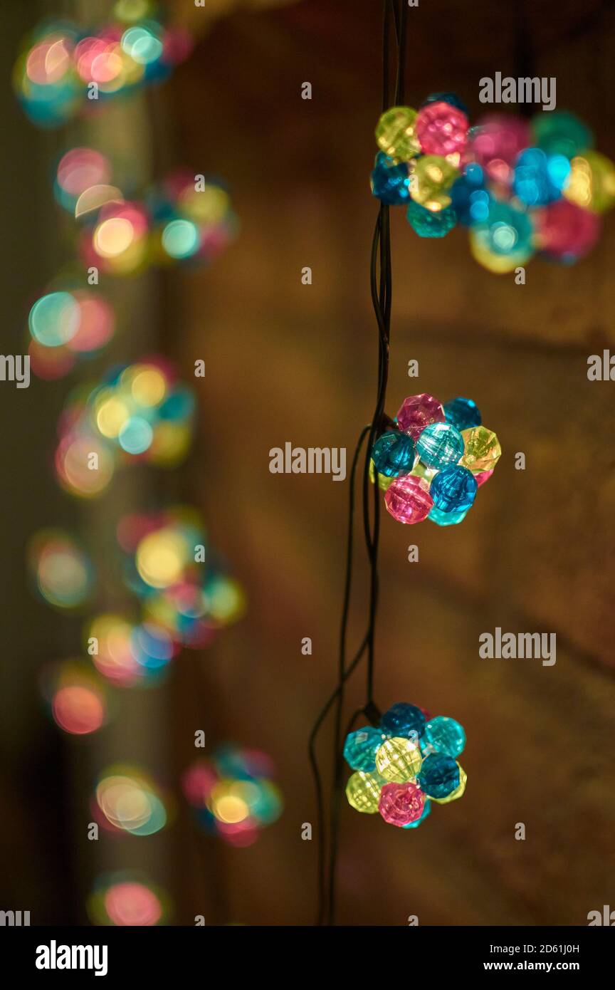 Colorful Christmas lights on a pebble wall Stock Photo - Alamy