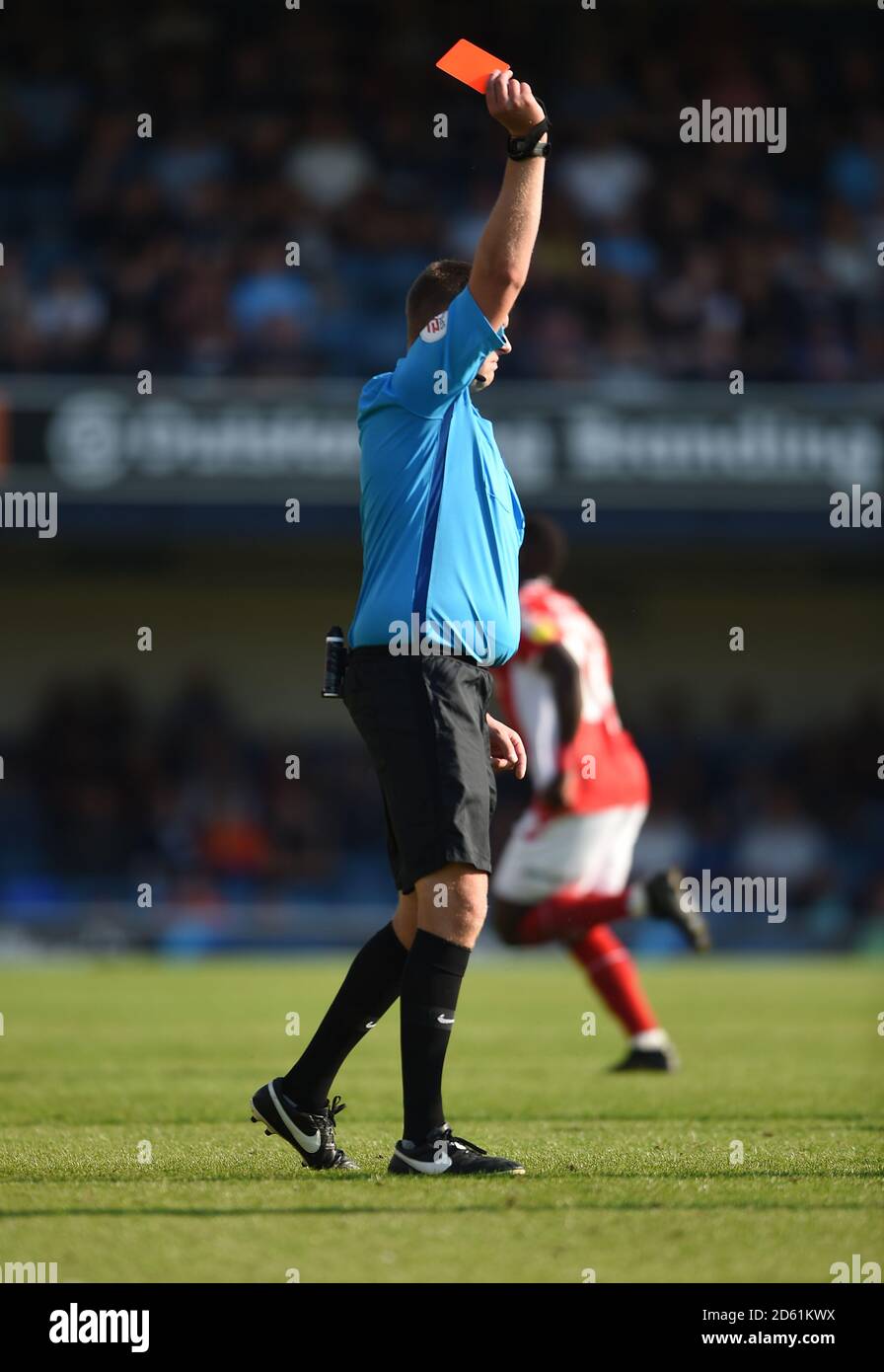 Referee Brett Huxtable shows a red card to Southend United's Mark Oxley ...