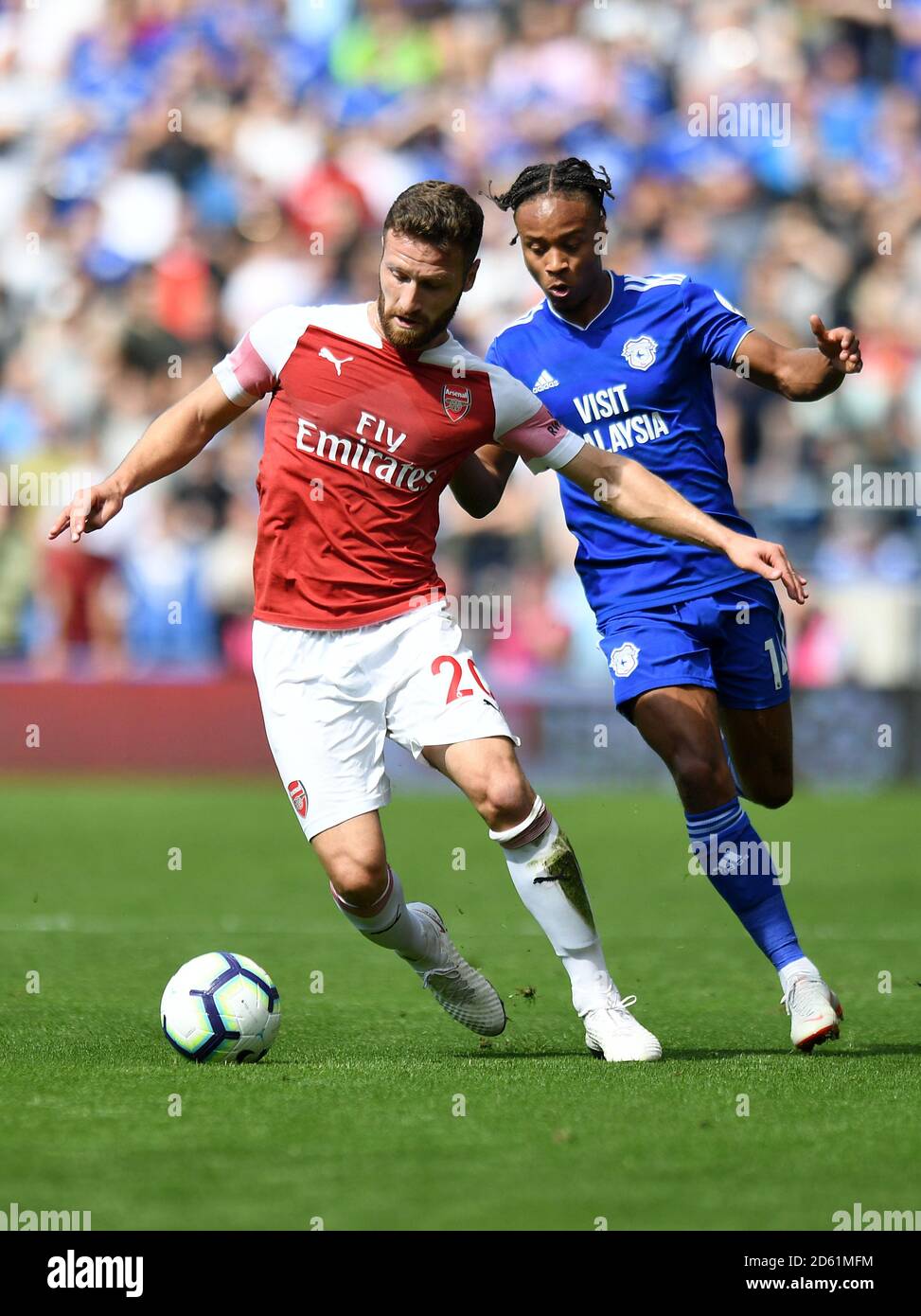 Arsenal's Shkodran Mustafi (left) and Cardiff City's Bobby Reid battle ...