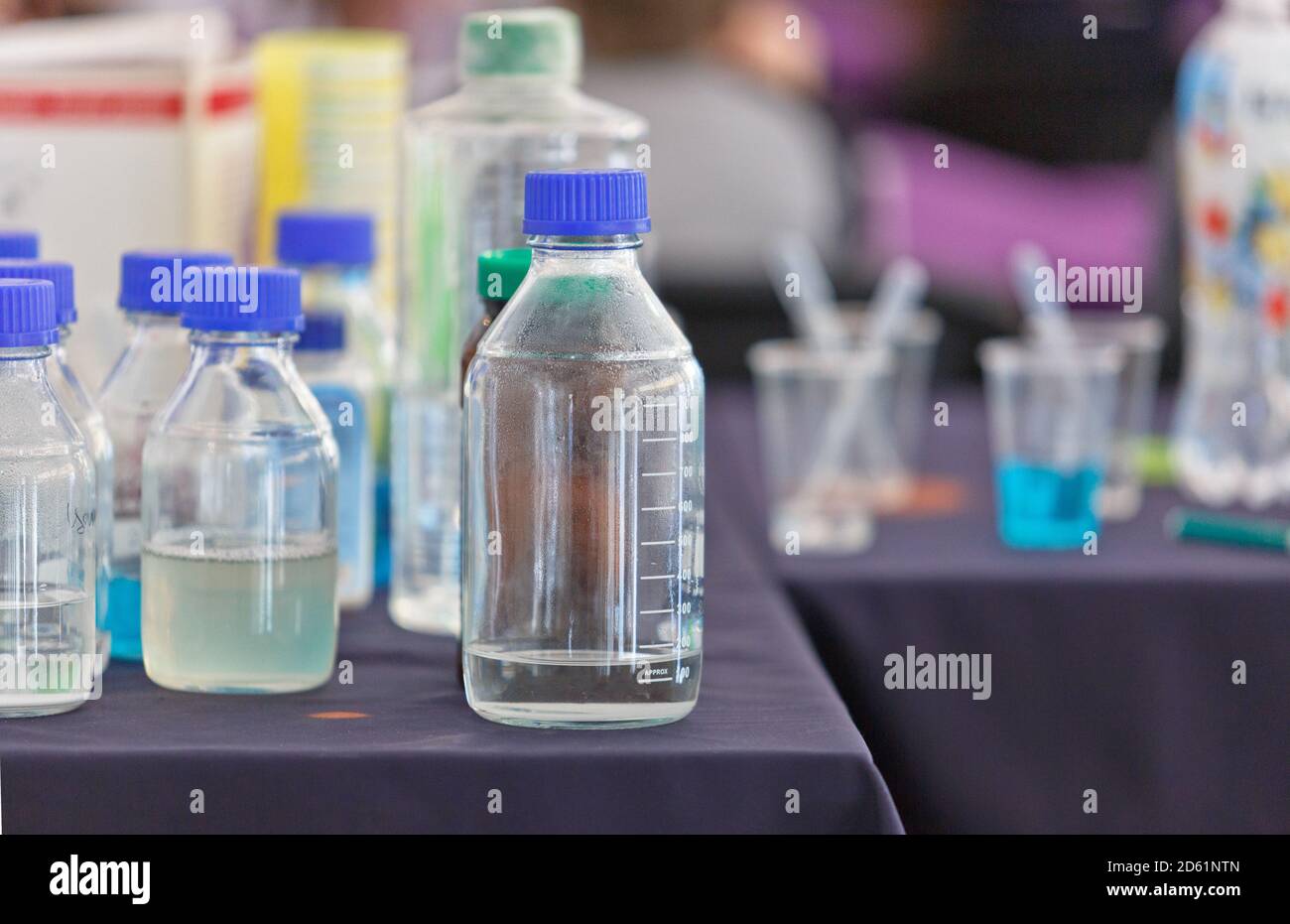 In the foreground is a bottle with a blue plastic lid. Laboratory ...