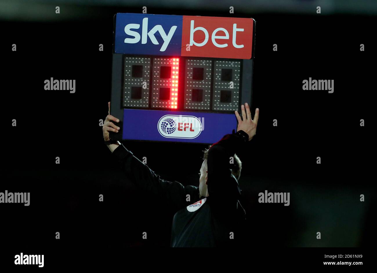 A match official holds up an electronic sign reading one minute of ...