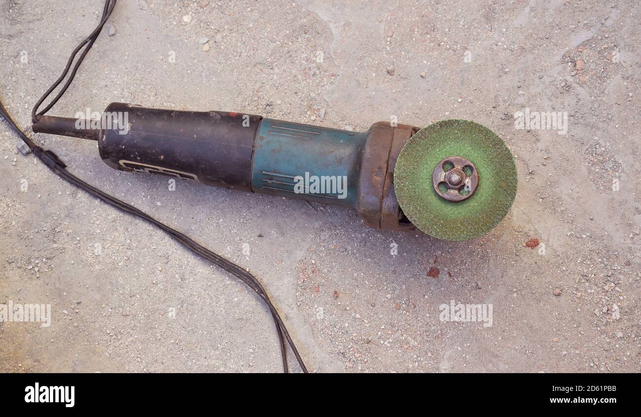 A static metal angle grinder lying in floor Stock Photo - Alamy