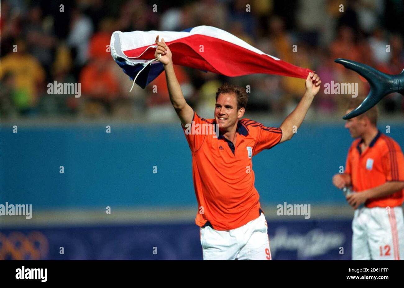 Holland's Piet-Hein Geeris holds aloft his country's flag after winning ...