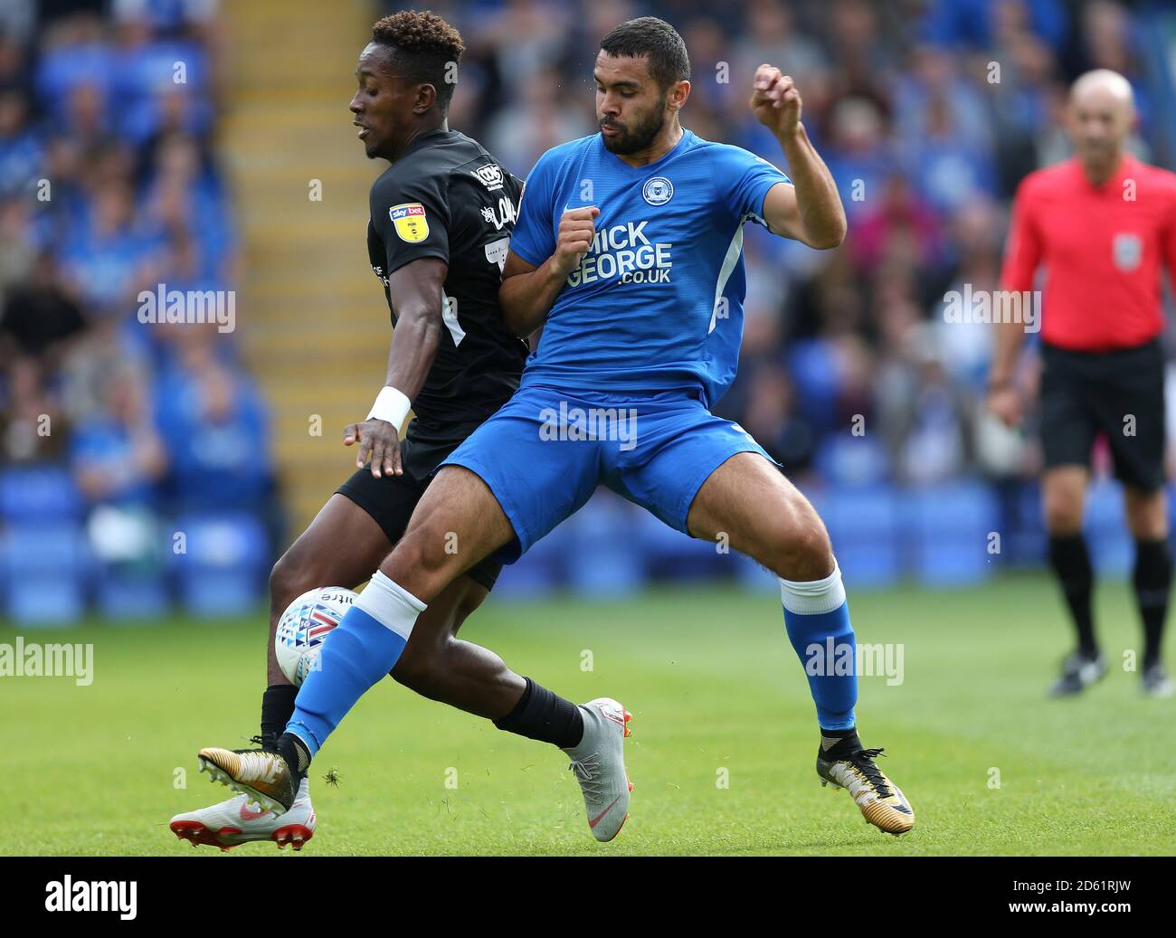 Peterborough United's Colin Daniel (right) and Portsmouth's Jamal Lowe ...