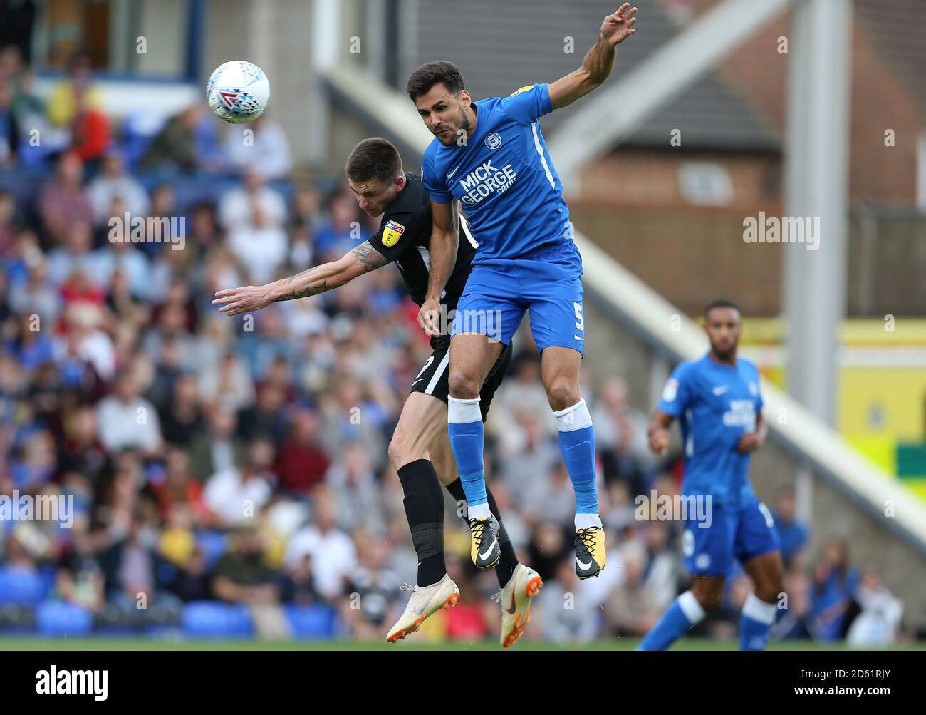 Peterborough United's Ryan Tafazolli (right) and Portsmouth's Oli ...