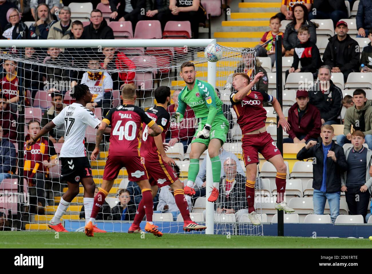 Charlton Athletic goalkeeper Jed Steer (centre) punches clear Stock ...