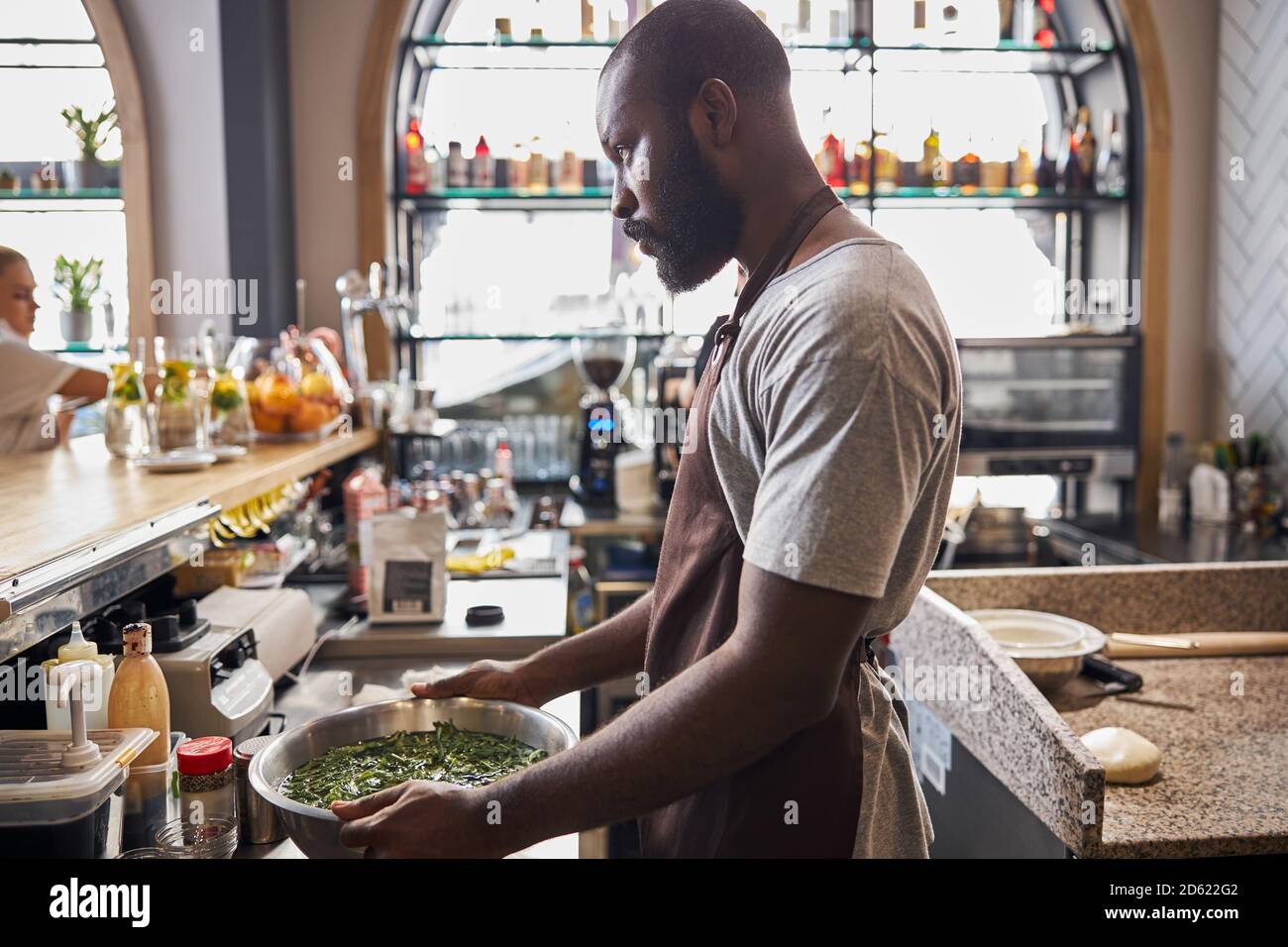 Professional male cooker working in open kitchen Stock Photo - Alamy