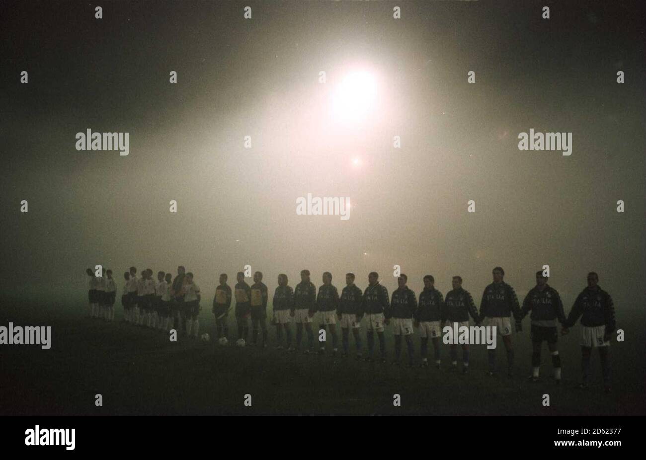 The teams line up in the dark as the floodlights are switched off so ...