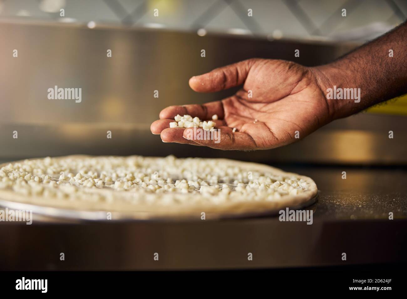 Male cooker making pizza in professional kitchen Stock Photo - Alamy