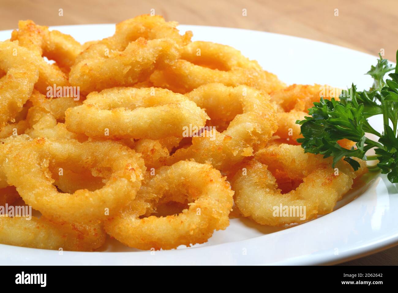 Crispy Calamari Rings on a White Plate Stock Photo - Alamy