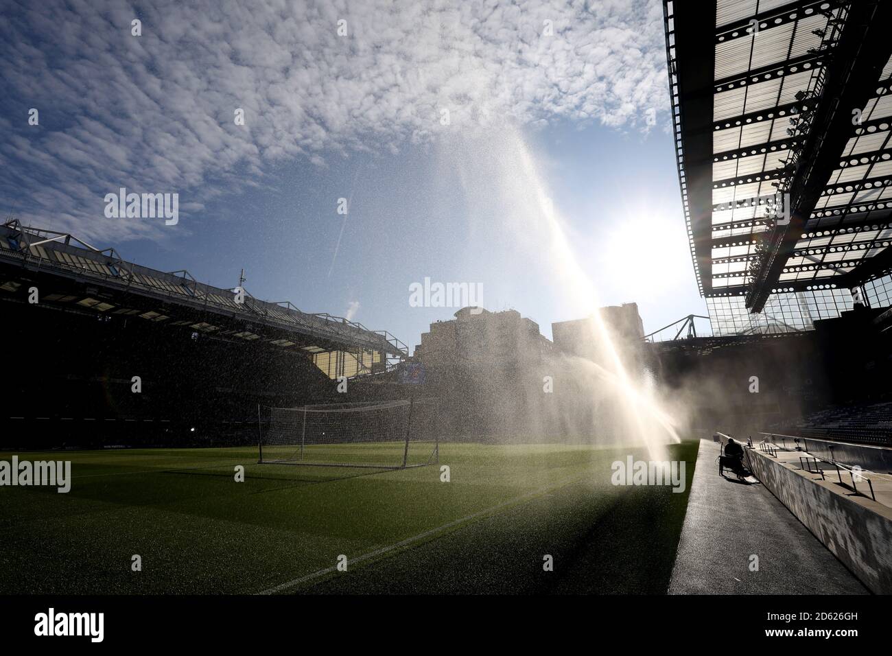 Sprinklers water the pitch before the game begins Stock Photo - Alamy