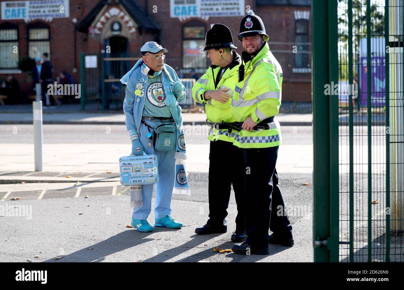 Manchester City fan "Pete the Badge" speaks to police outside the ...