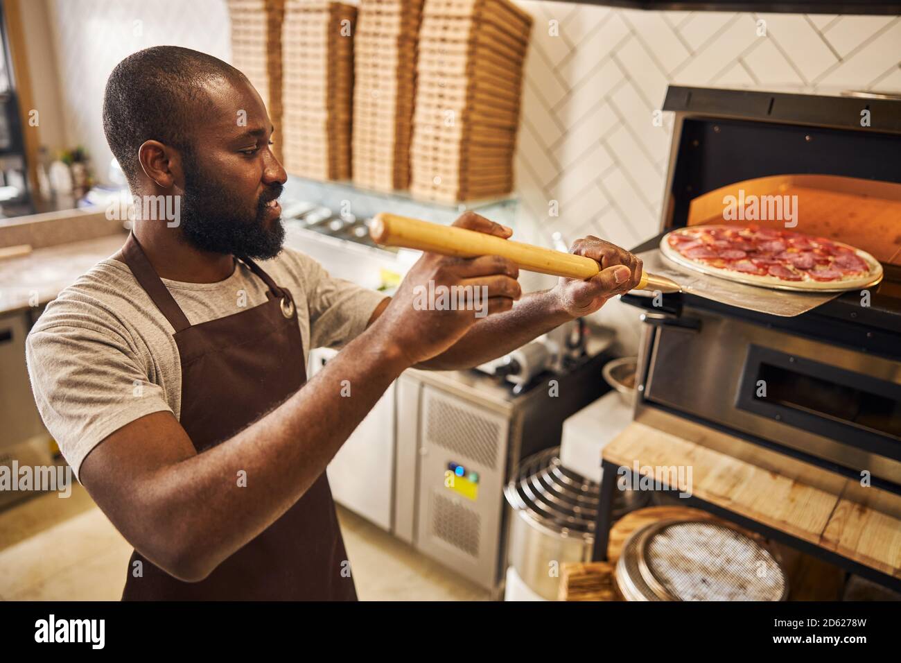 Young man in pizzeria hi-res stock photography and images - Alamy