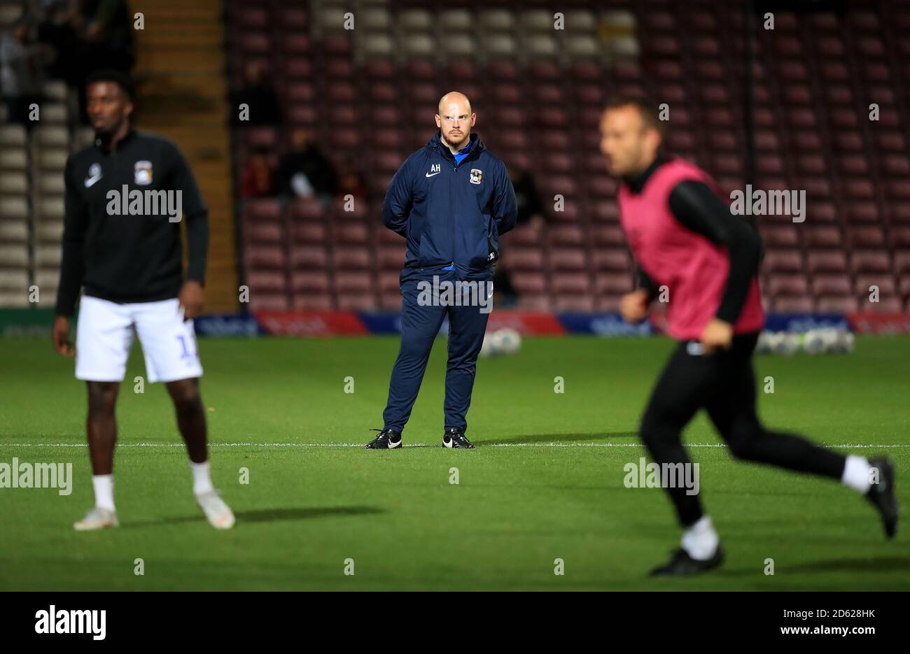 Coventry City physiotherapist Andrew Hemming (centre) looks on during ...